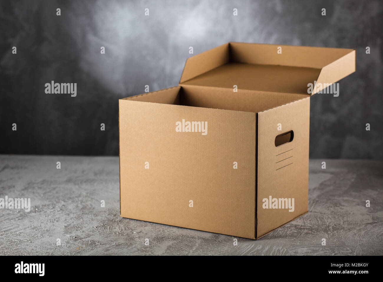 Cardboard box on grey background Stock Photo - Alamy
