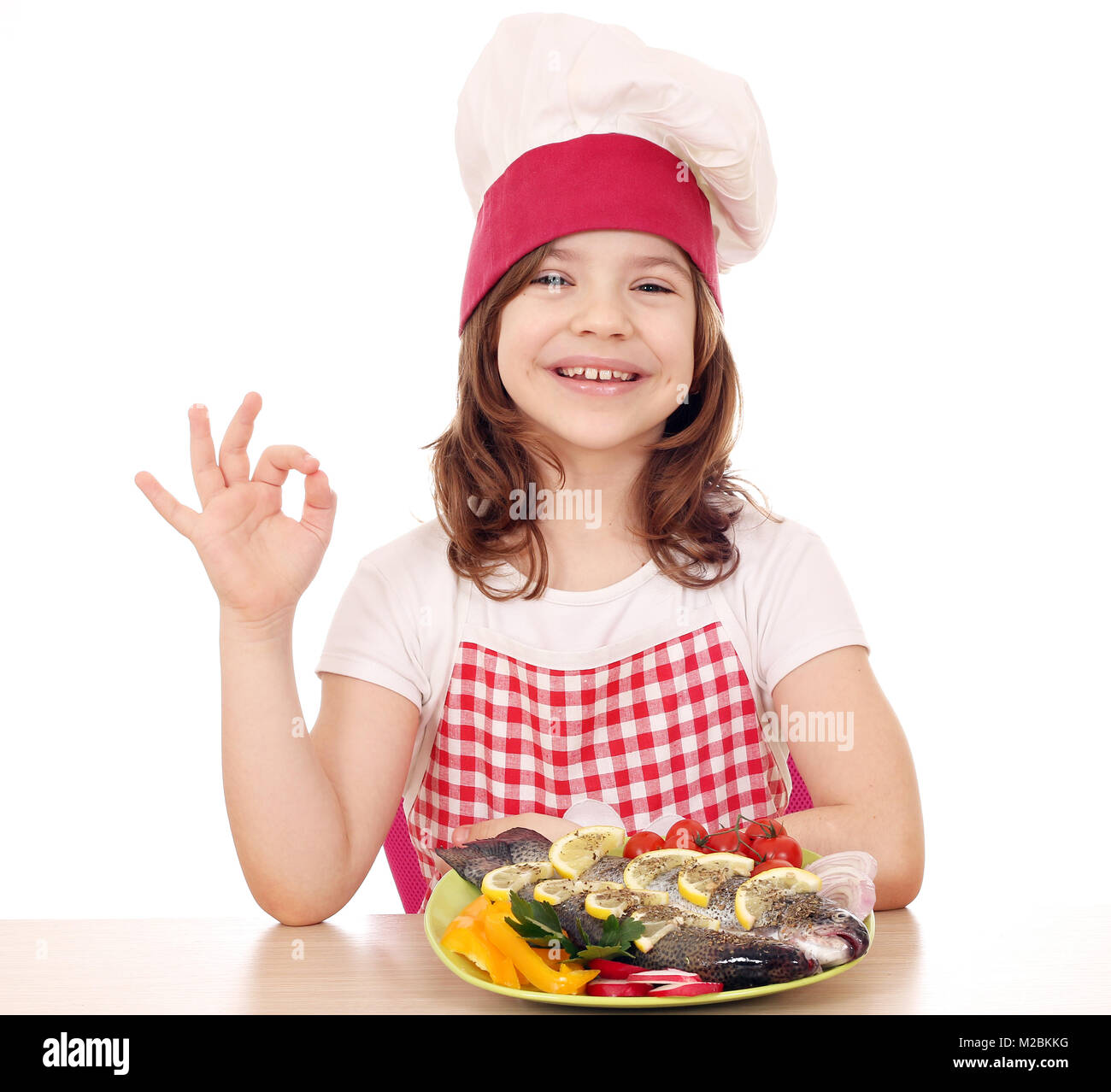 happy little girl cook with trout on plate and ok hand sign Stock Photo ...