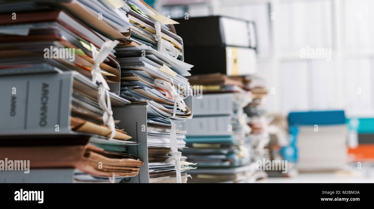 Stacks of paperwork and files in the office: work overload, files ...