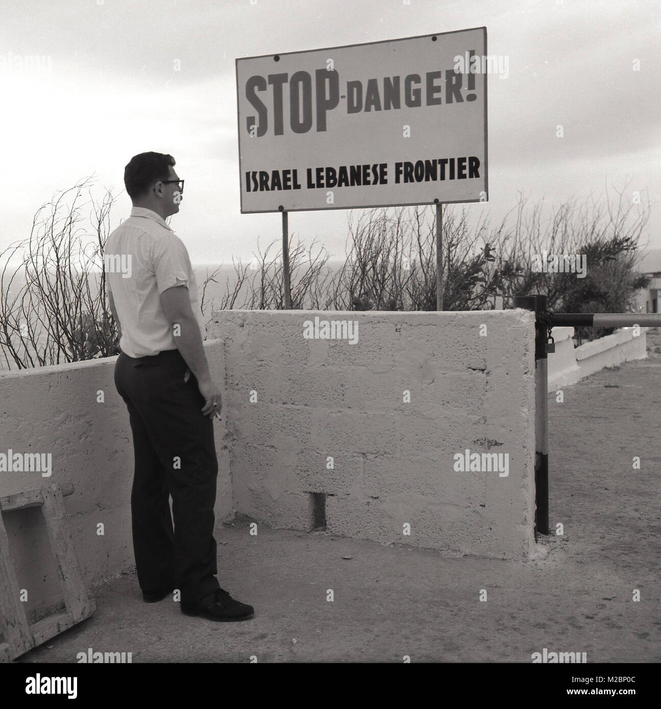 1950s, historical, picture shows a man looking at a Stop-Danger sign at ...