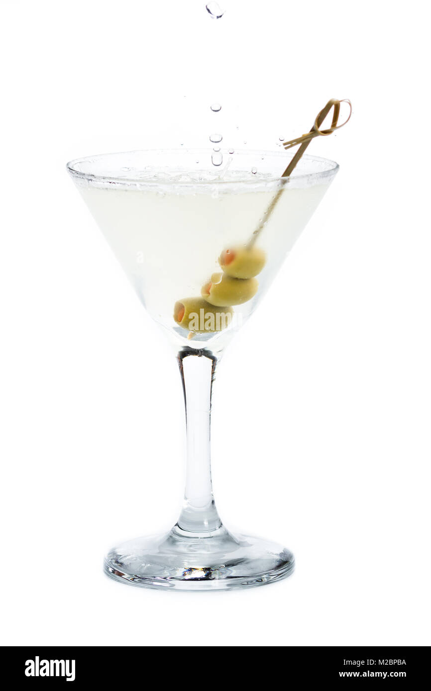 Freshly poured dirty vodka martini with green olives served on a ...