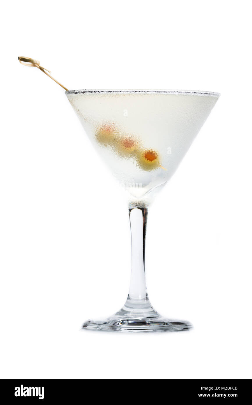 Freshly poured dirty vodka martini with green olives served on a ...