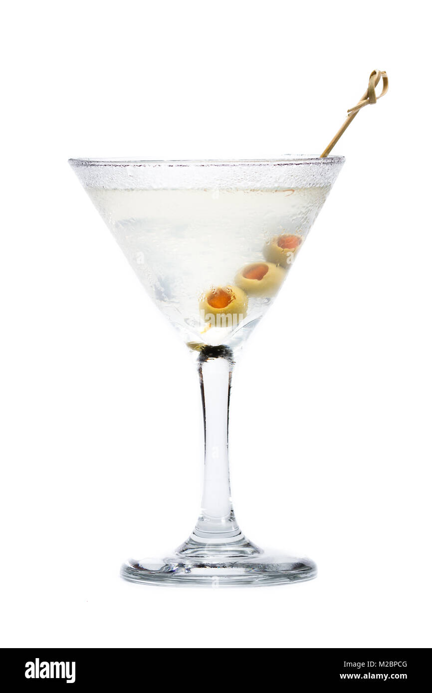 Freshly poured dirty vodka martini with green olives served on a ...