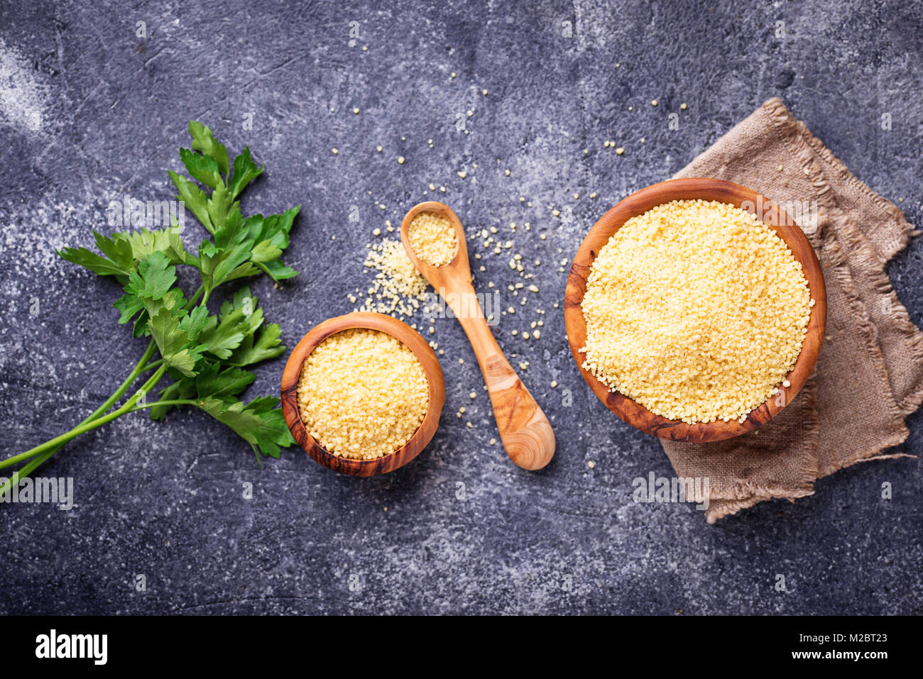 Couscous grain in wooden bowl Stock Photo - Alamy