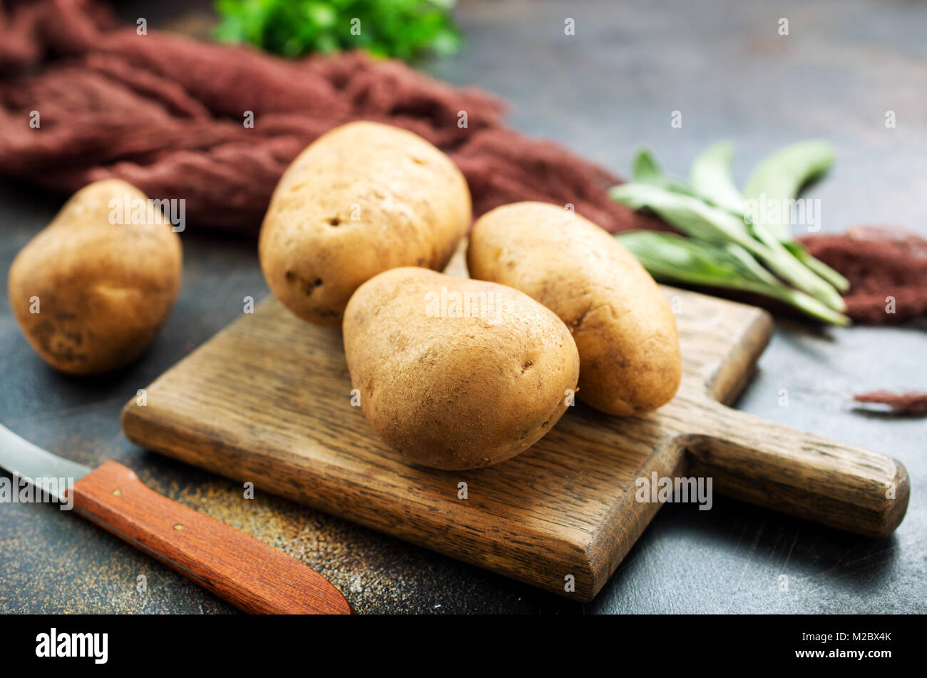 potato on board and on a table Stock Photo - Alamy