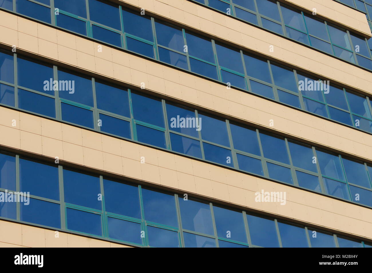 Modern office building wall made of blue glass and steel frame ...