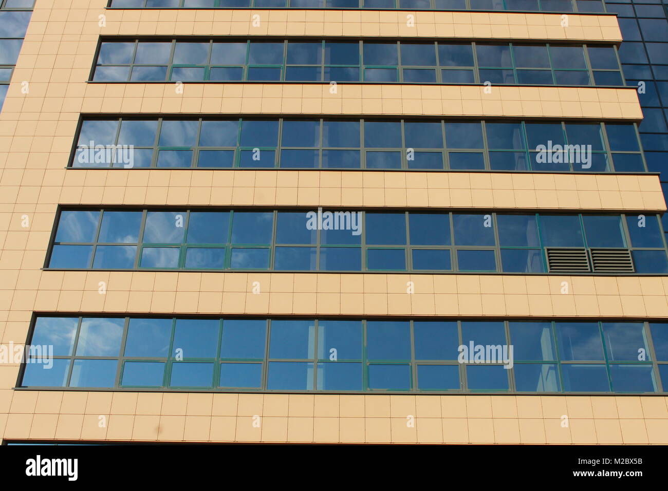 Modern office building wall made of blue glass and steel frame ...