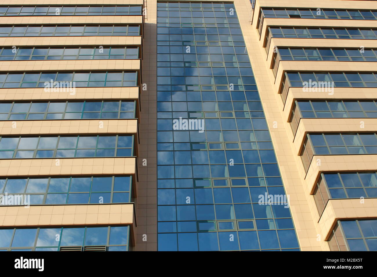 Modern office building wall made of blue glass and steel frame ...