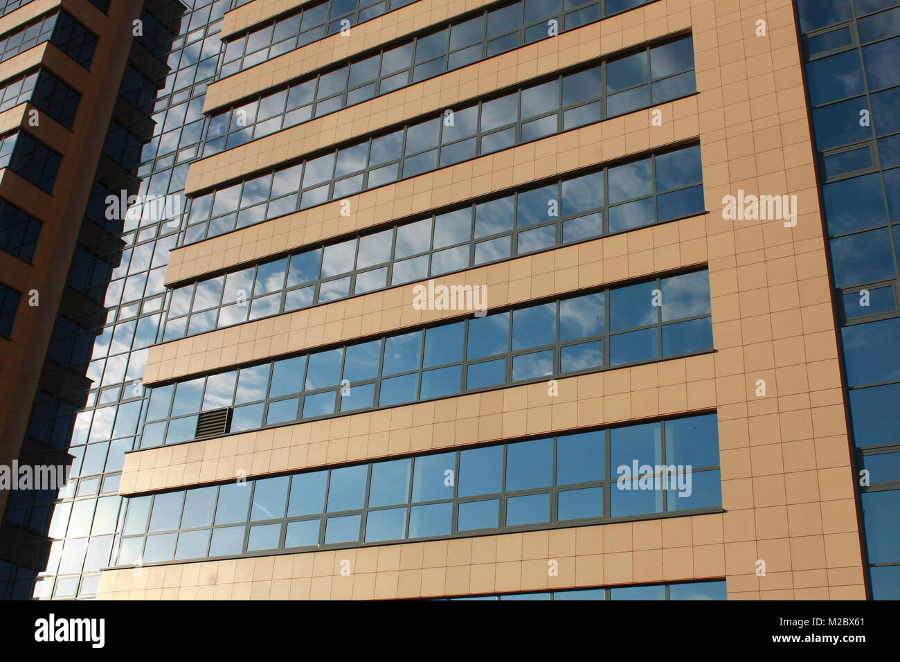Modern office building wall made of blue glass and steel frame ...