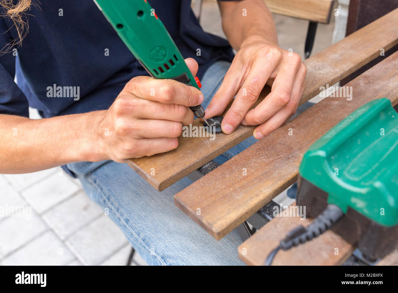 Artist engraver using an electric tool for stone engraving ornaments ...