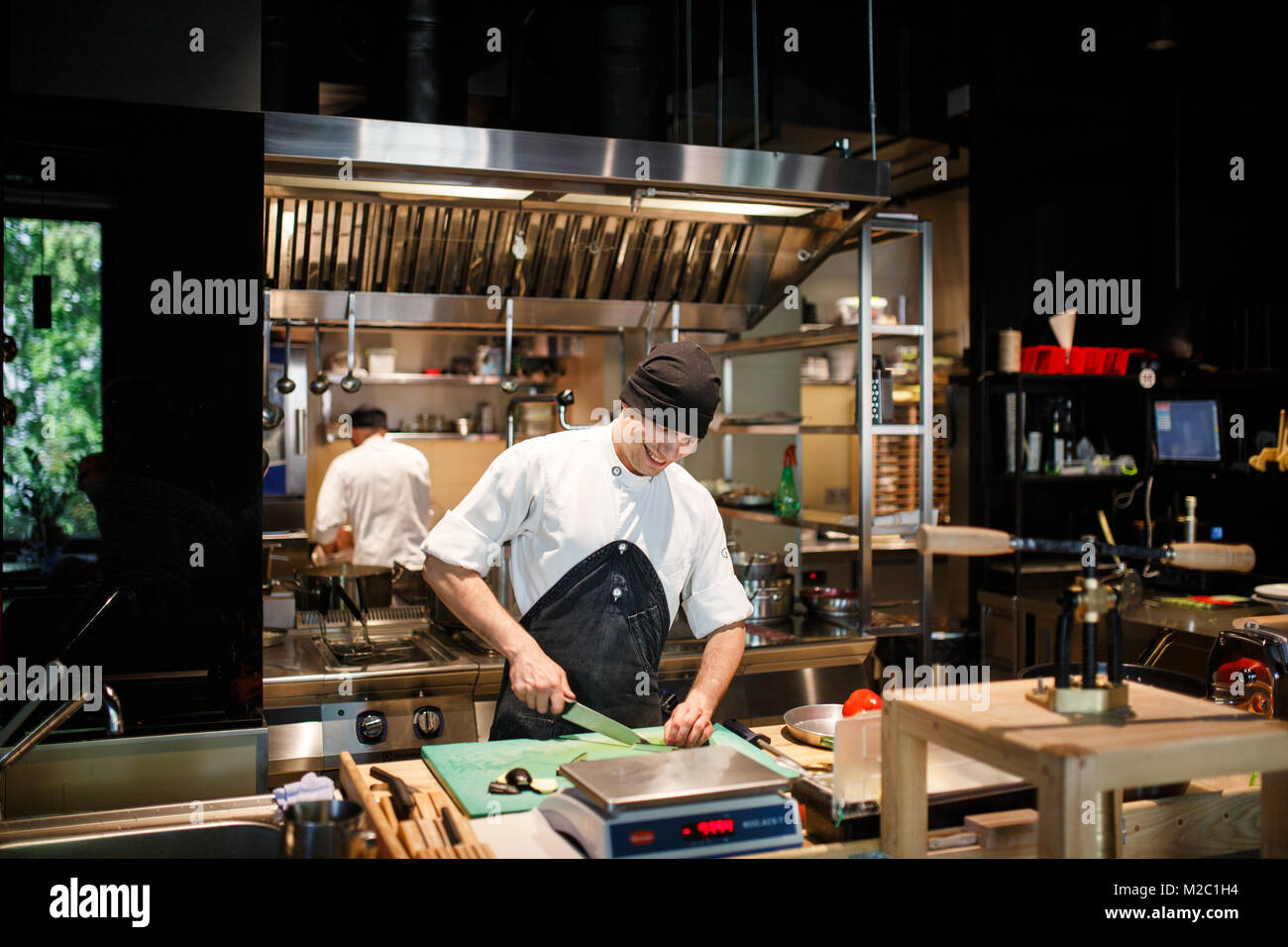 Cook cut vegetables in the kitchen In a restaurant Stock Photo - Alamy