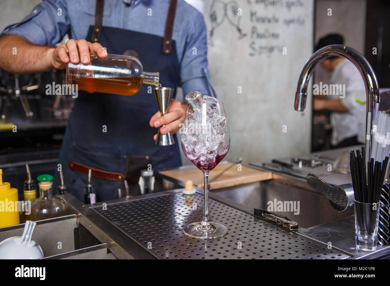 Bartender behind the bar preparing cocktails hi-res stock photography ...