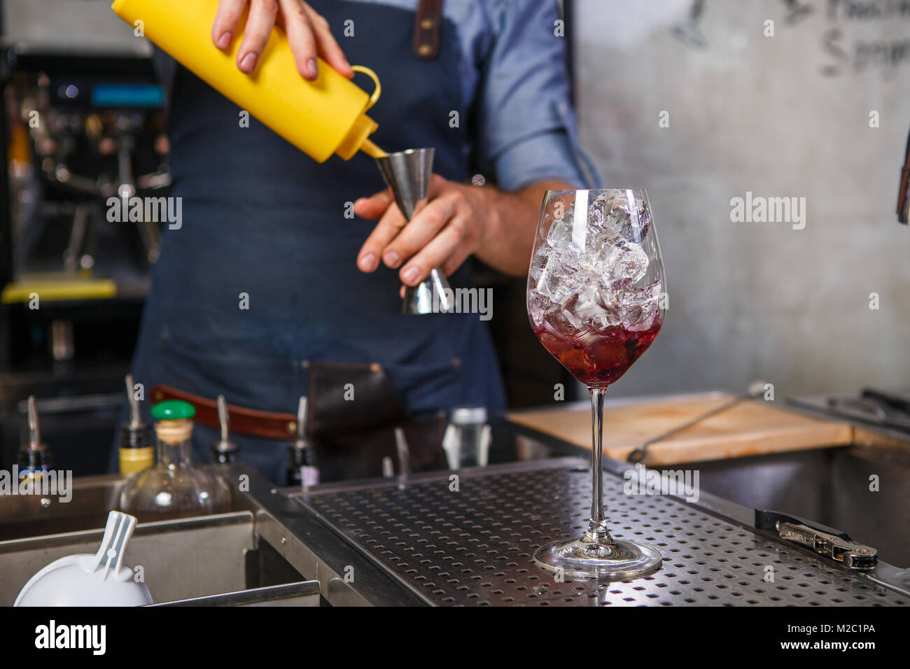 Bartender behind the bar preparing cocktails hi-res stock photography ...