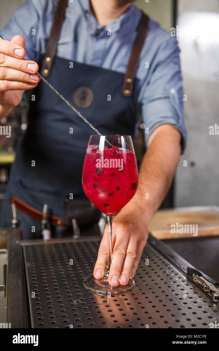 Bartender behind the bar preparing cocktails hi-res stock photography ...