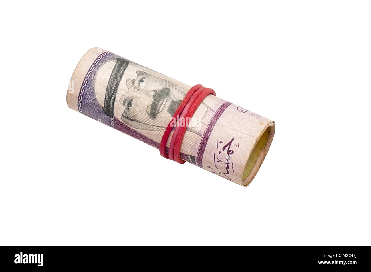 Rolled Saudi Arabian Riyal banknotes with a rubber ring, isolated on ...