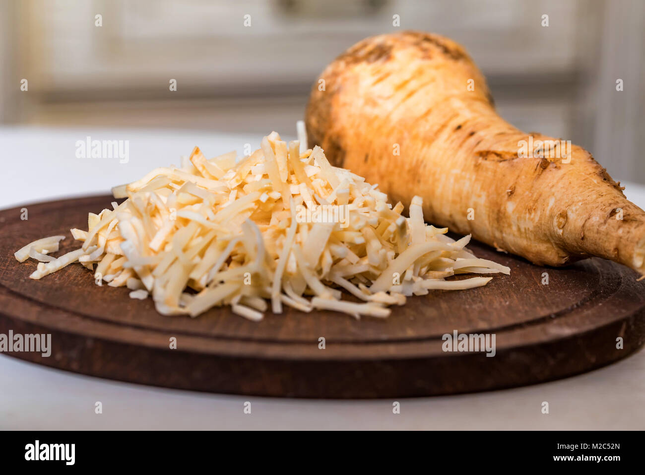 Chopped parsnip on wooden board close Stock Photo - Alamy
