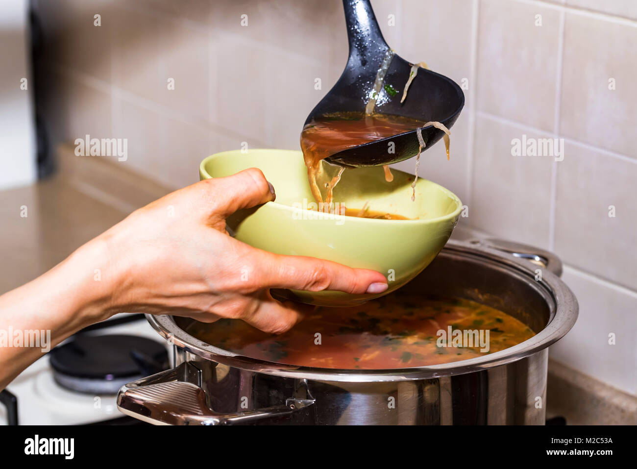 Pouring vegetable broth into soup hi-res stock photography and images ...