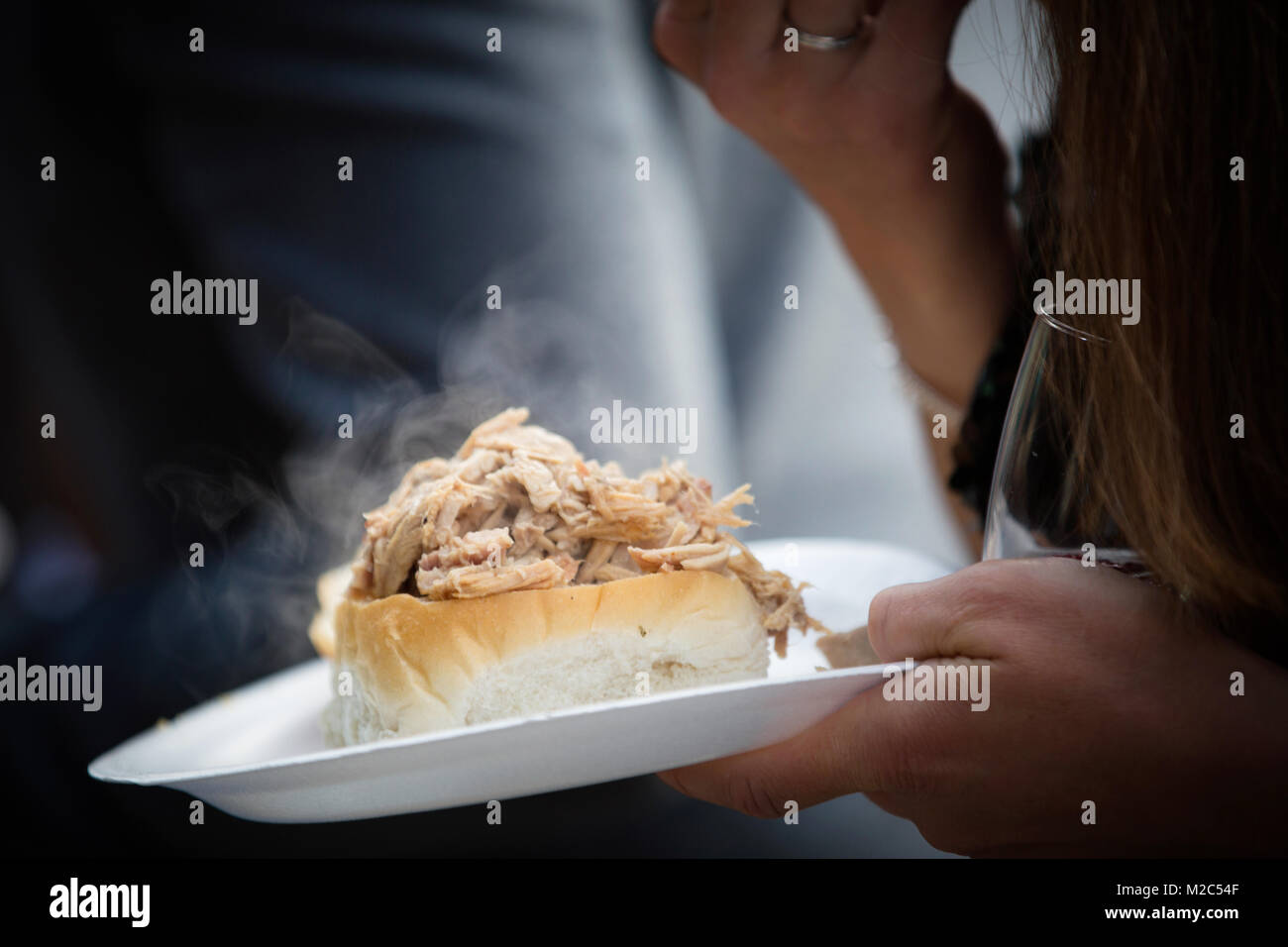 Woman eating food from paper plate, mid section, close-up Stock Photo ...