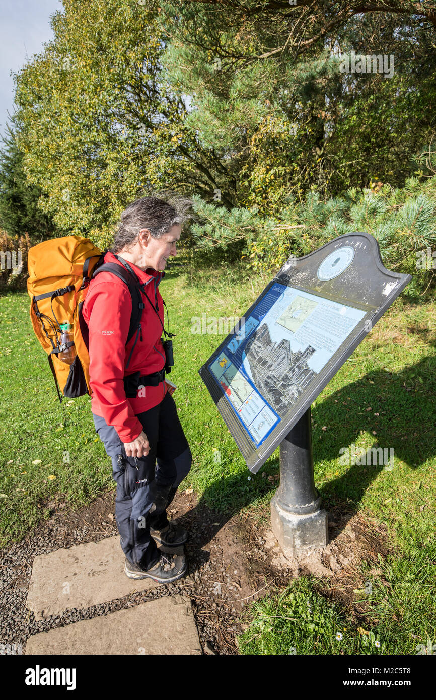 Tourist hiker reading information sign about Lanercost Priory on ...