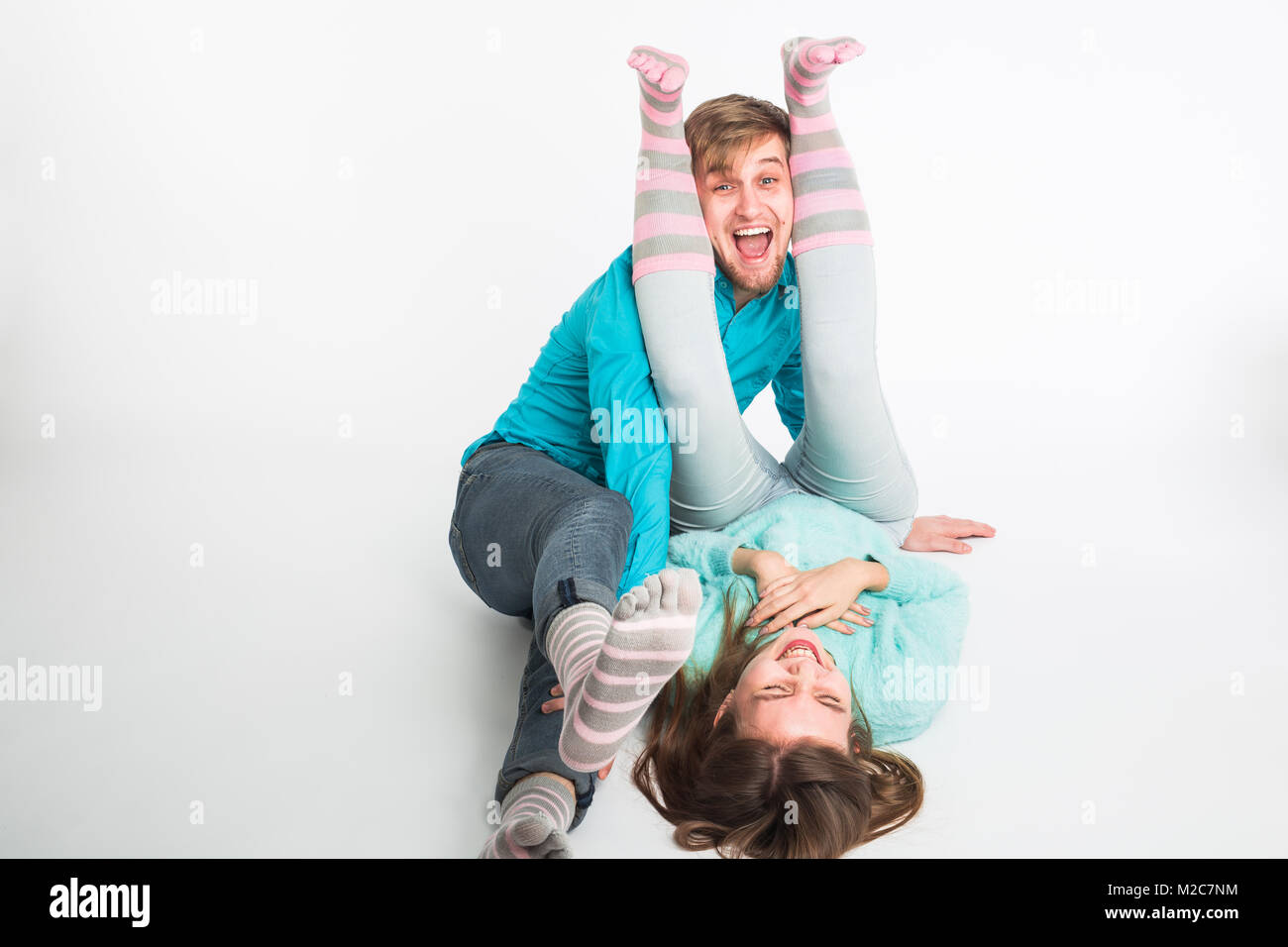 Portrait funny moments of excited couple fooling around to camera on ...
