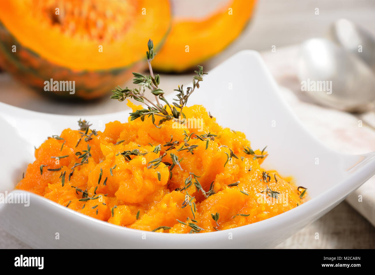 Baked pumpkin with a tender, juicy pulp flavored with thyme. Close-up ...