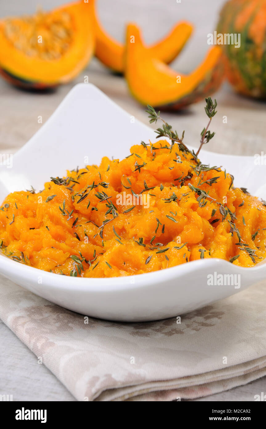 Baked pumpkin with a tender, juicy pulp flavored with thyme. Close-up ...