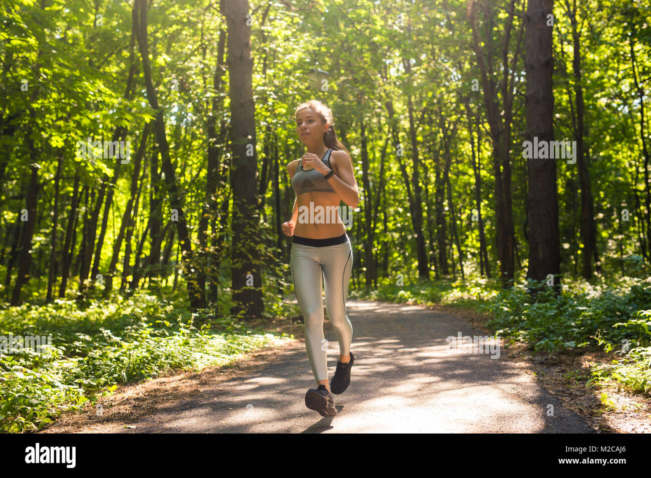 healthy lifestyle young fitness woman running outdoors Stock Photo - Alamy