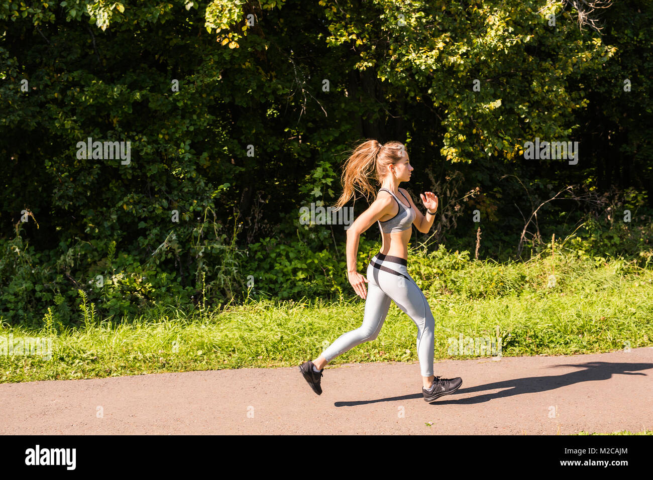 healthy lifestyle young fitness woman running outdoors Stock Photo - Alamy