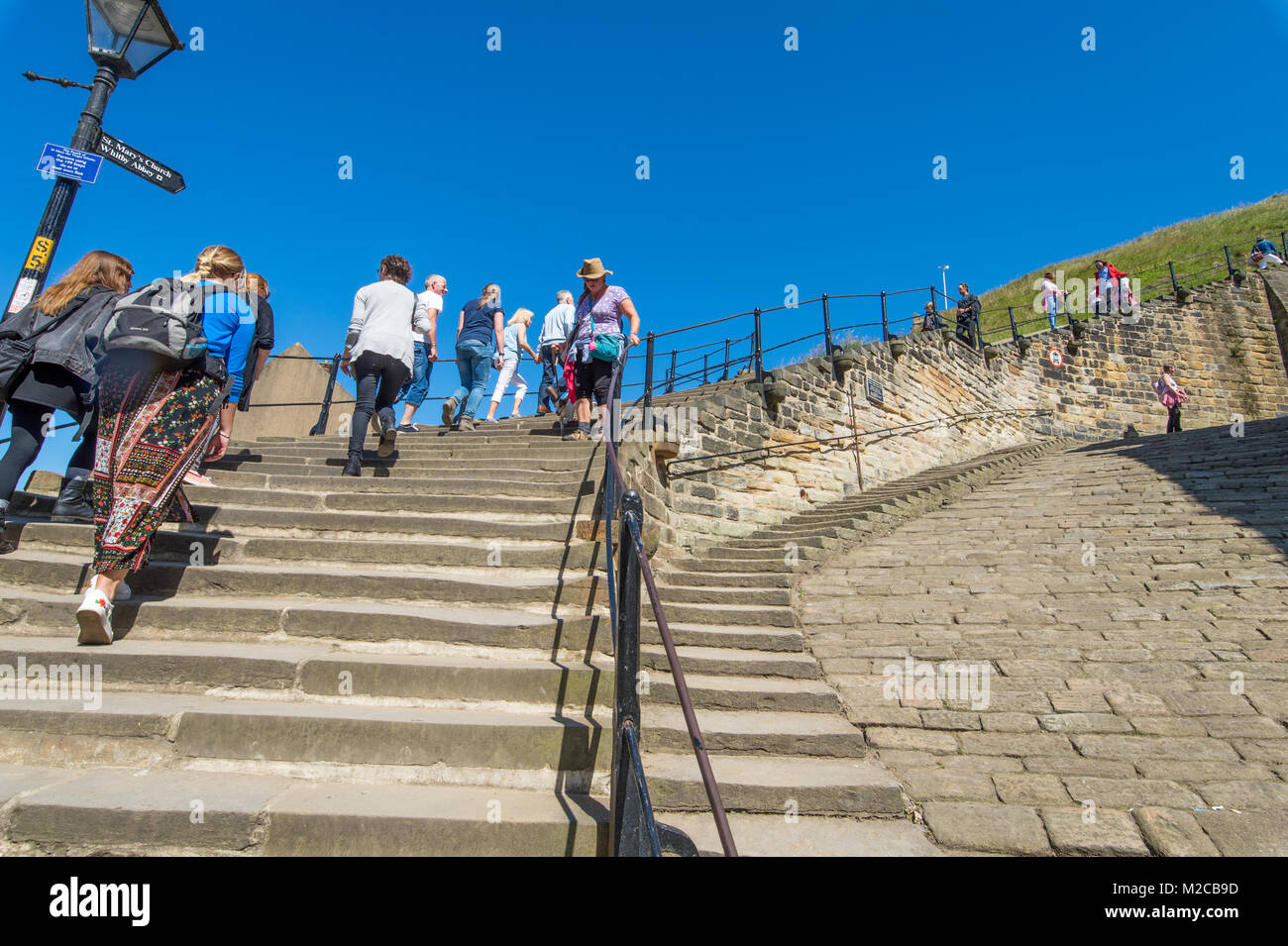 Tourists climb steep 199 steps up towards Whitby Abbey, Whitby ...