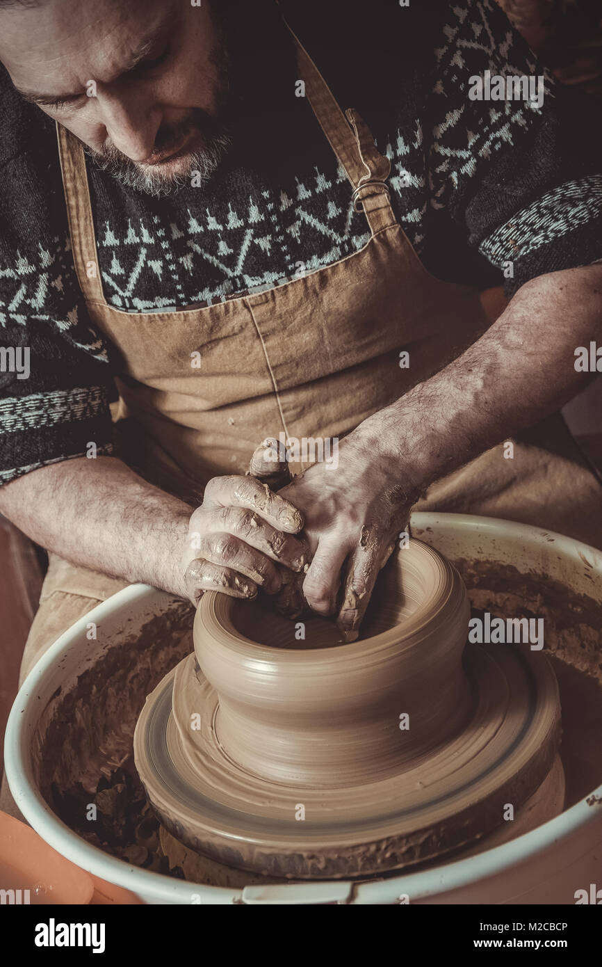 elderly man making pot using pottery wheel in studio Stock Photo - Alamy