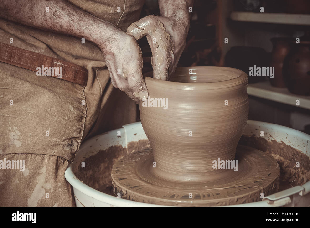 elderly man making pot using pottery wheel in studio Stock Photo - Alamy