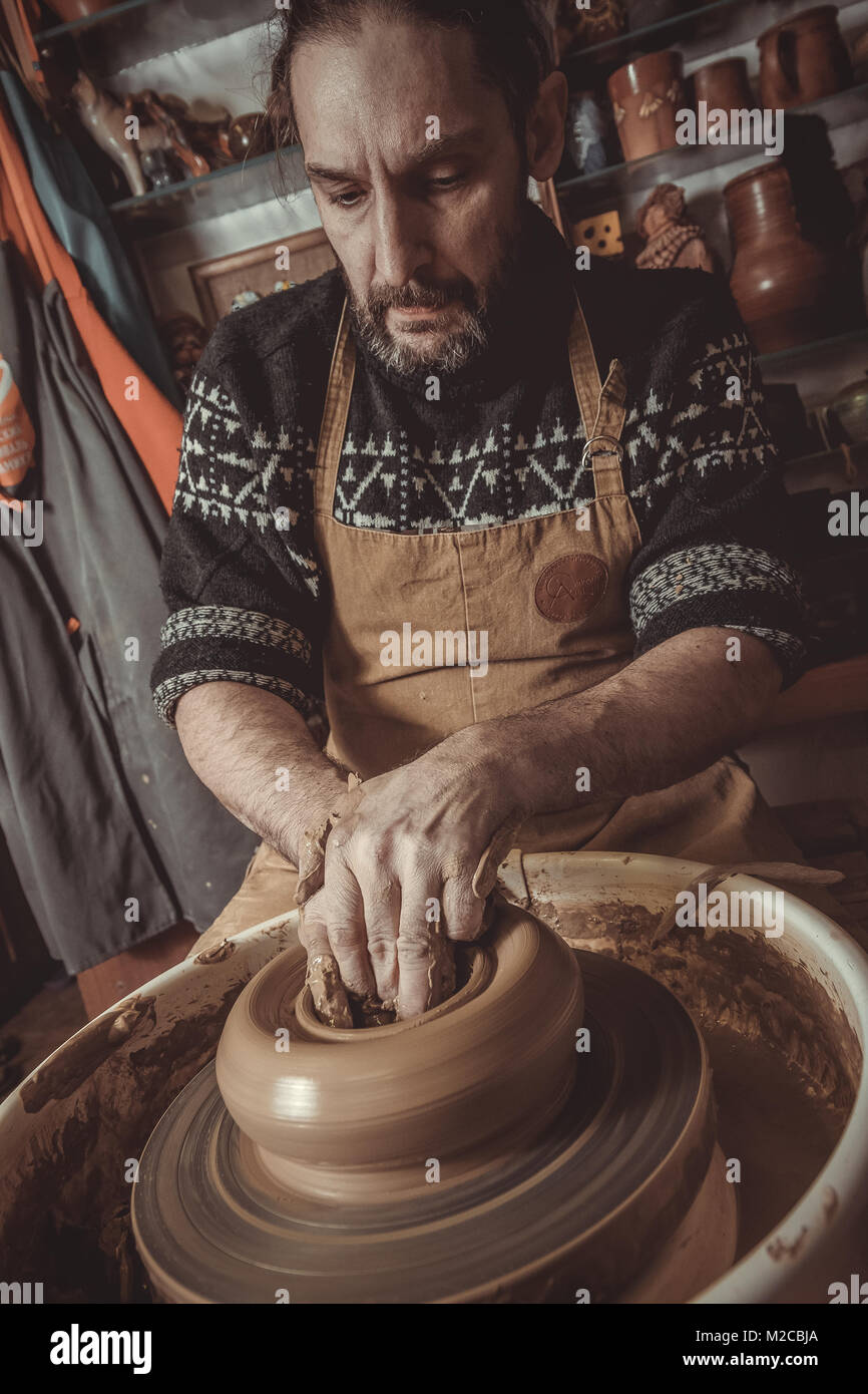elderly man making pot using pottery wheel in studio Stock Photo - Alamy