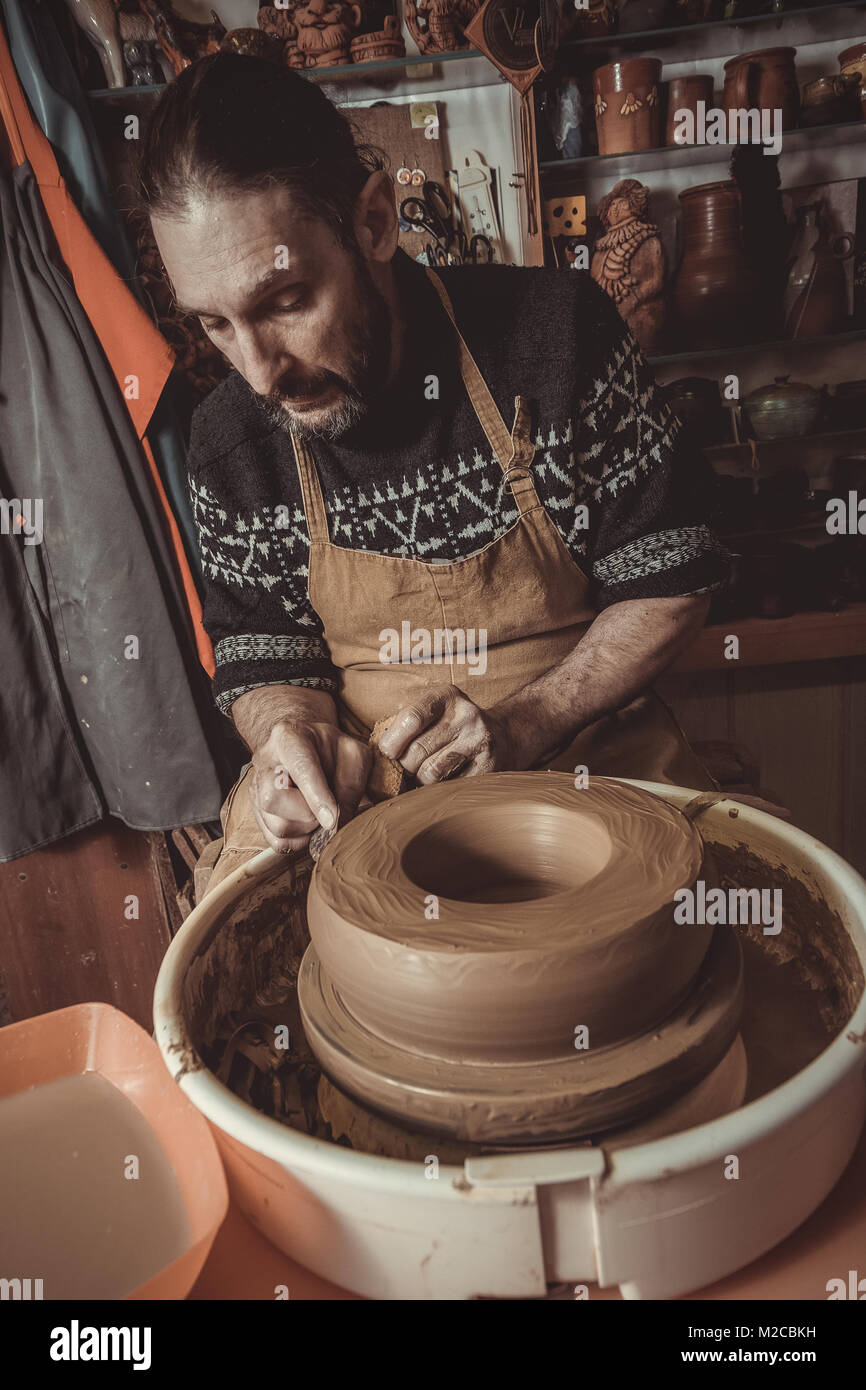 elderly man making pot using pottery wheel in studio Stock Photo - Alamy