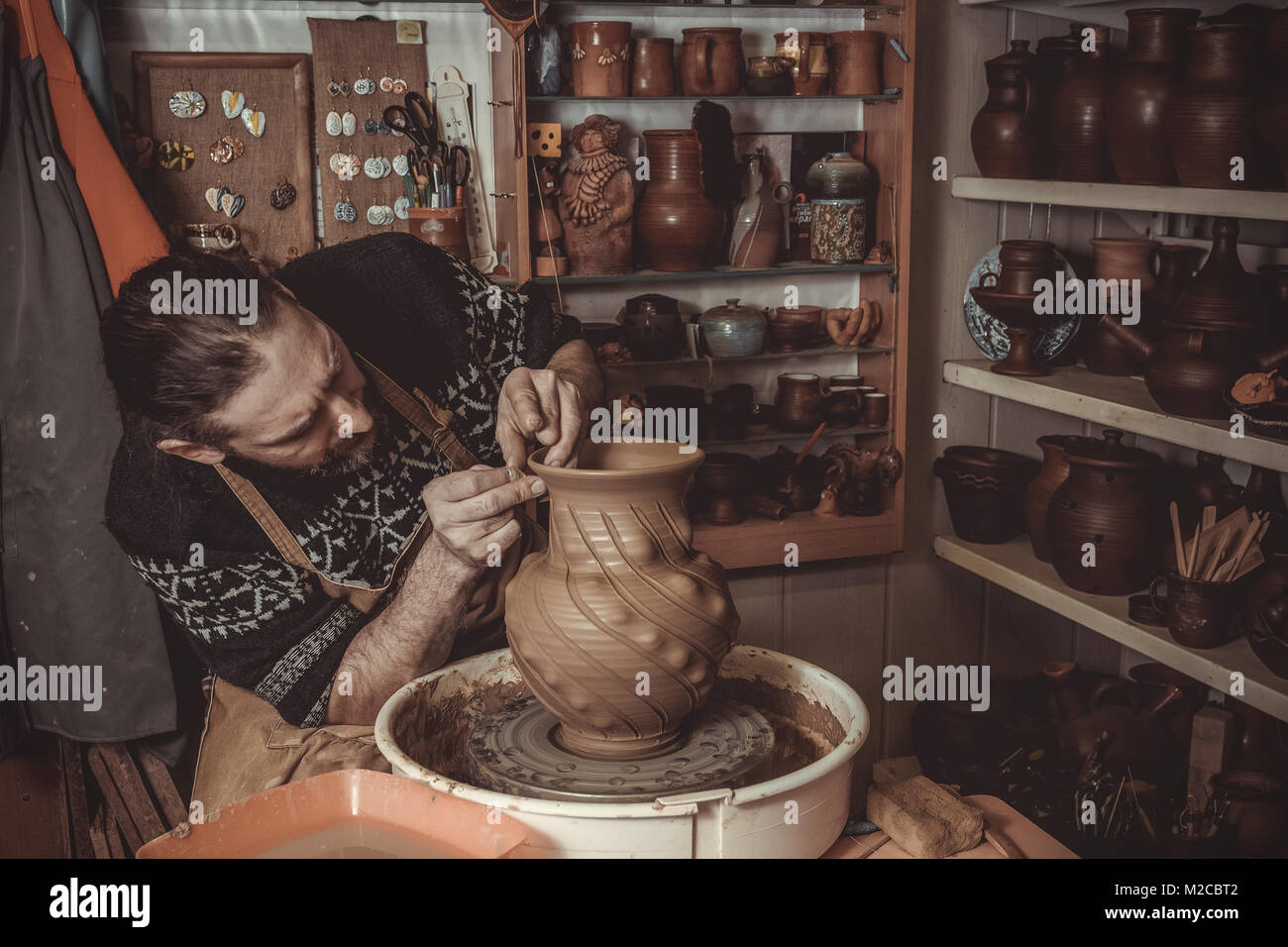 elderly man making pot using pottery wheel in studio Stock Photo - Alamy