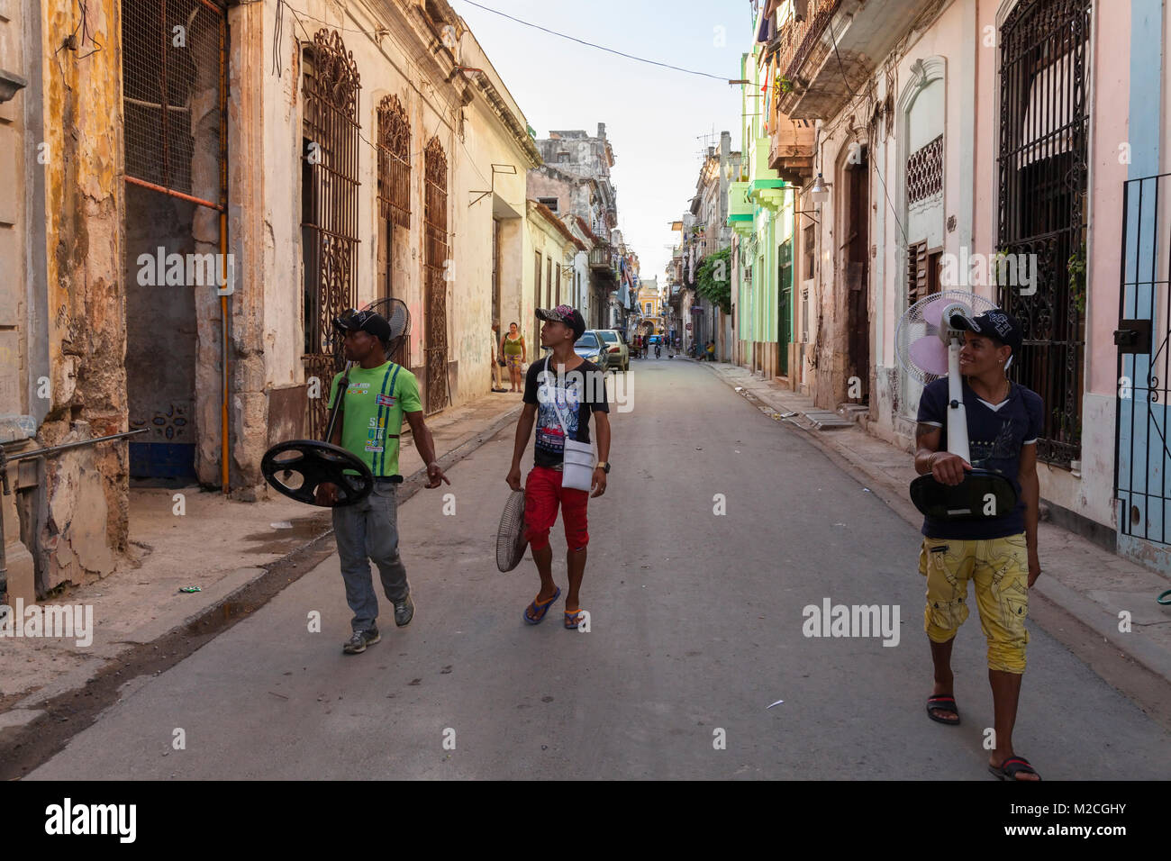 Cuban men carrying household fans down the street in Havana, Cuba Stock ...