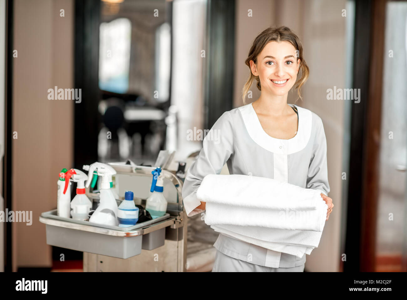 Chambermaid in the hotel corridor Stock Photo - Alamy