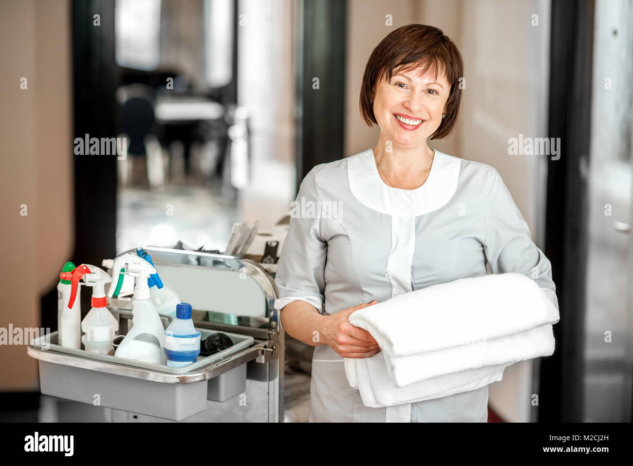 Chambermaid in the hotel corridor Stock Photo - Alamy