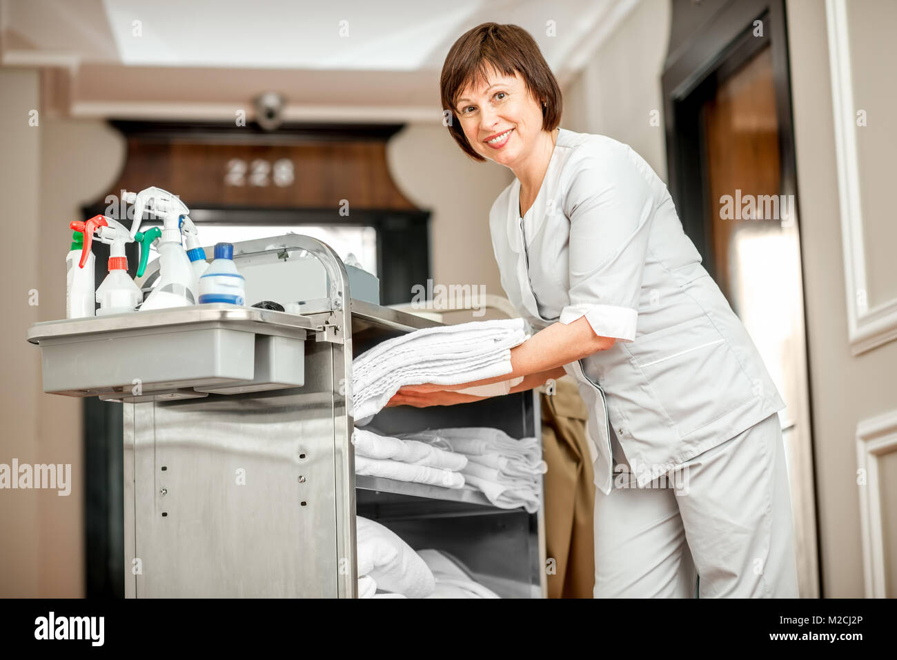 Chambermaid in the hotel corridor Stock Photo - Alamy
