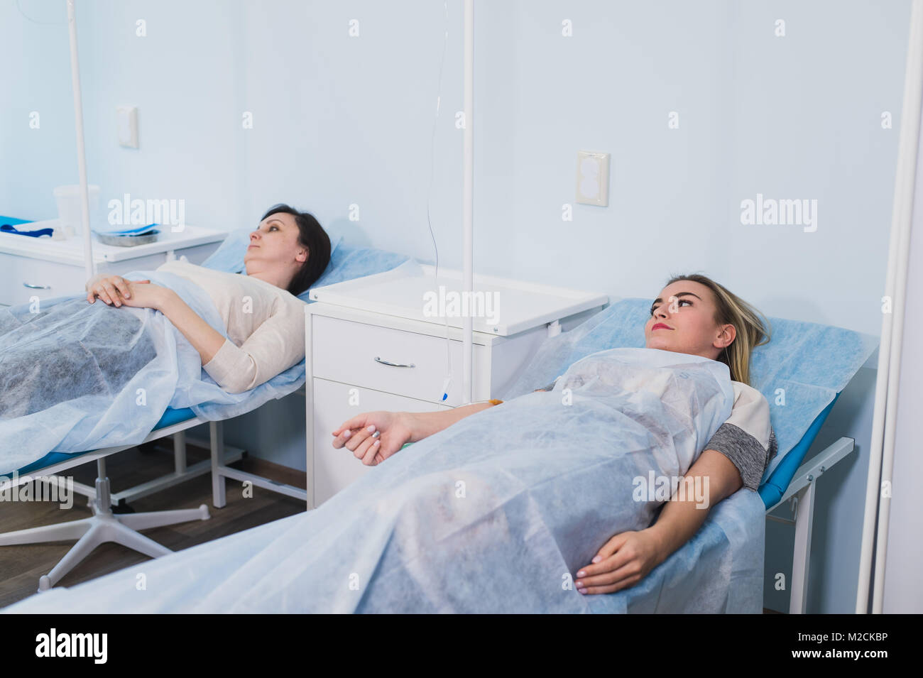 Female patient resting in medical bed at the hospital ward Stock Photo ...