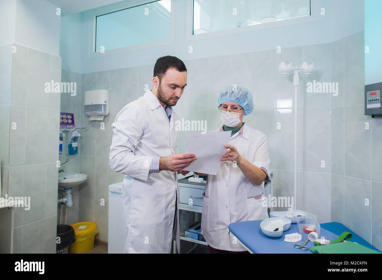 Healthcare: Doctor and patient discussing blood-test results Stock ...