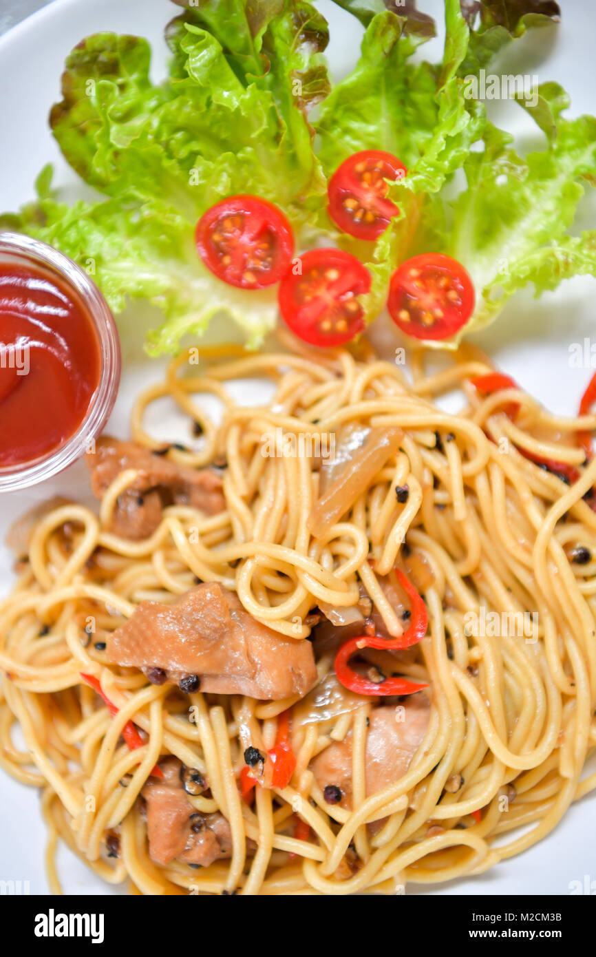 Italian spaghetti with chicken on white plate Stock Photo - Alamy