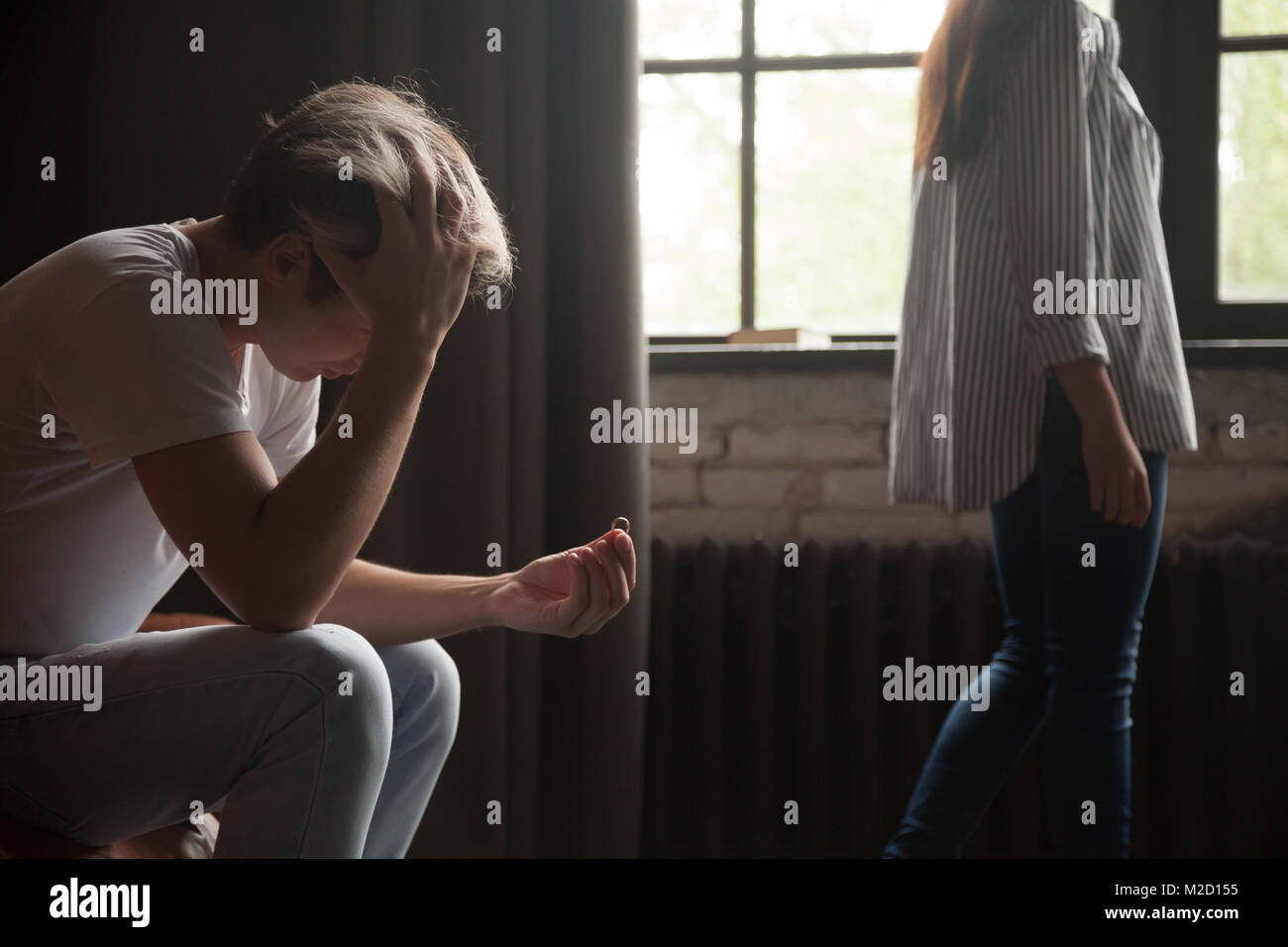 Frustrated man holding wedding ring, couple breaking up divorce Stock ...