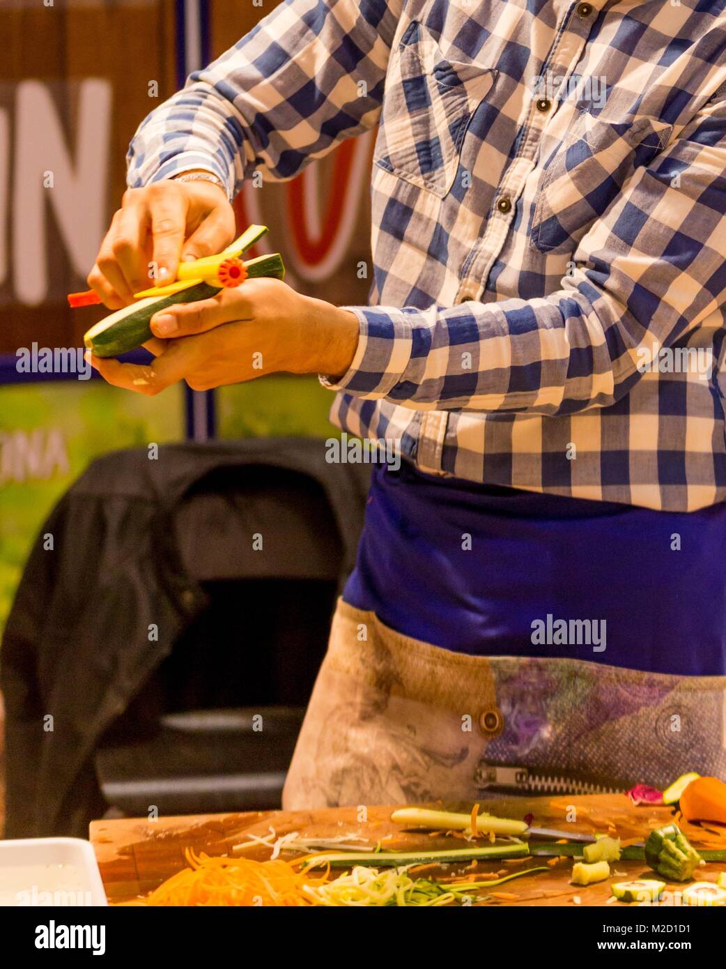 Man working and demonstrating the operation of a zucchini size Stock ...