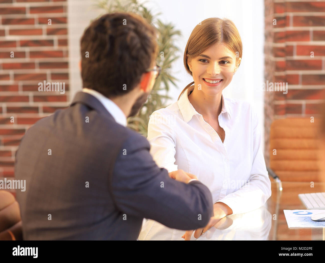 handshake Manager and the client in the office Stock Photo - Alamy