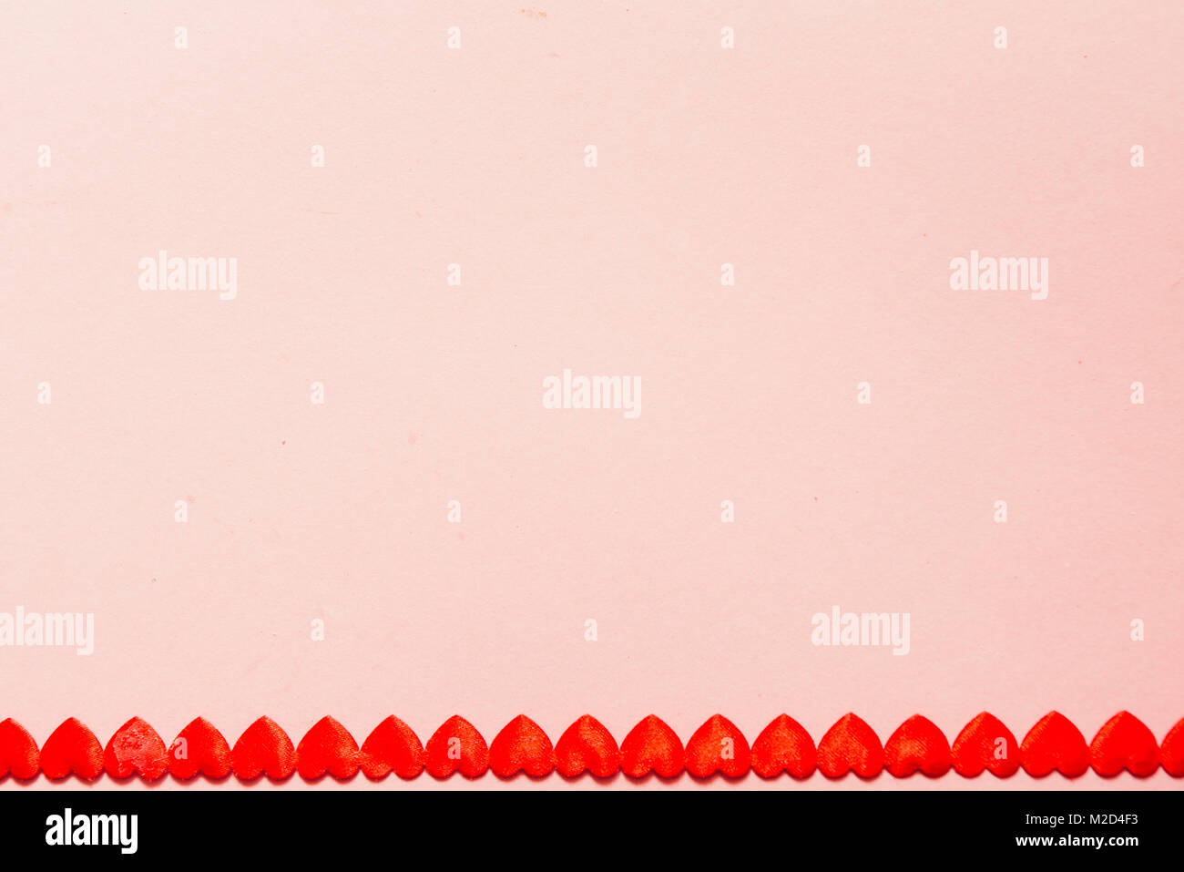 Heart shaped ribbon borders a pink background, valentine's day theme ...