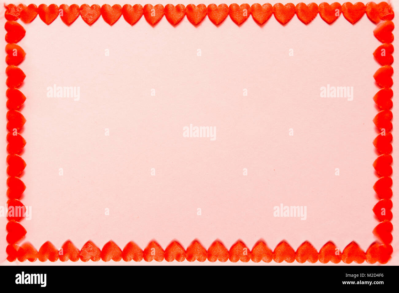 Heart shaped ribbon borders a pink background, valentine's day theme ...