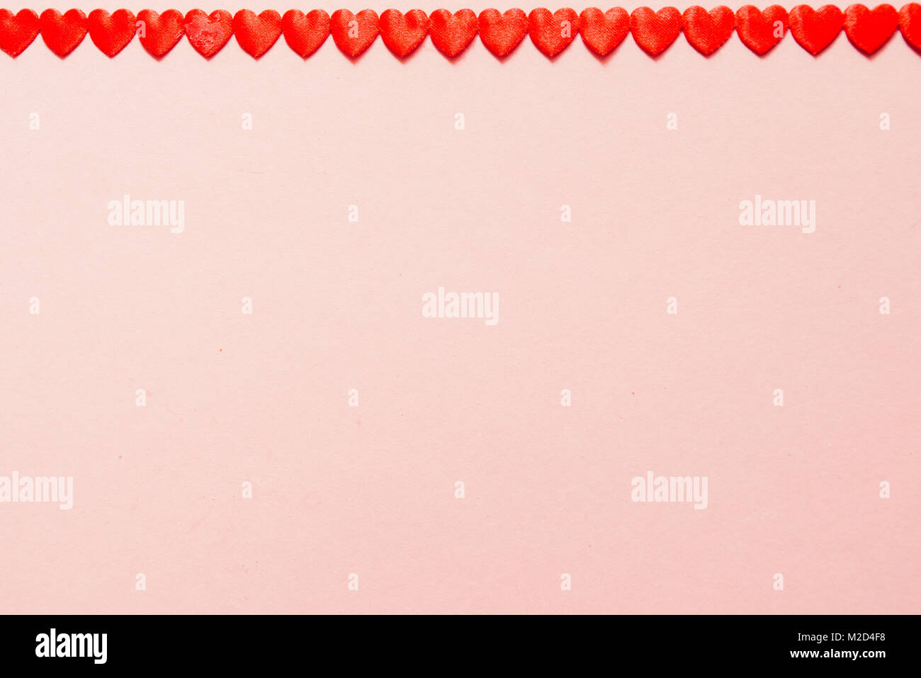 Heart shaped ribbon borders a pink background, valentine's day theme ...