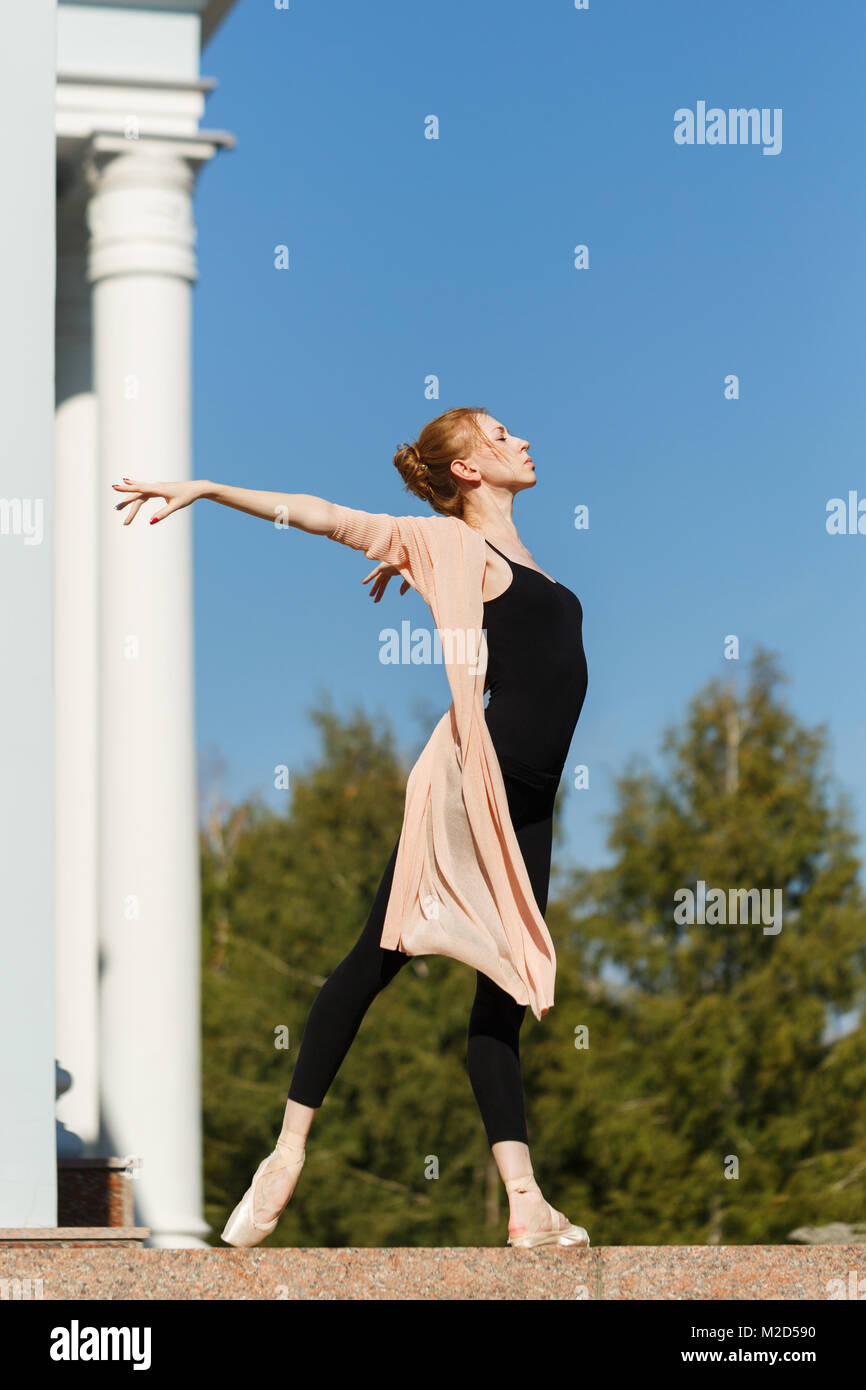 Young graceful ballerina dancing at the building. Beauty and grace of ...