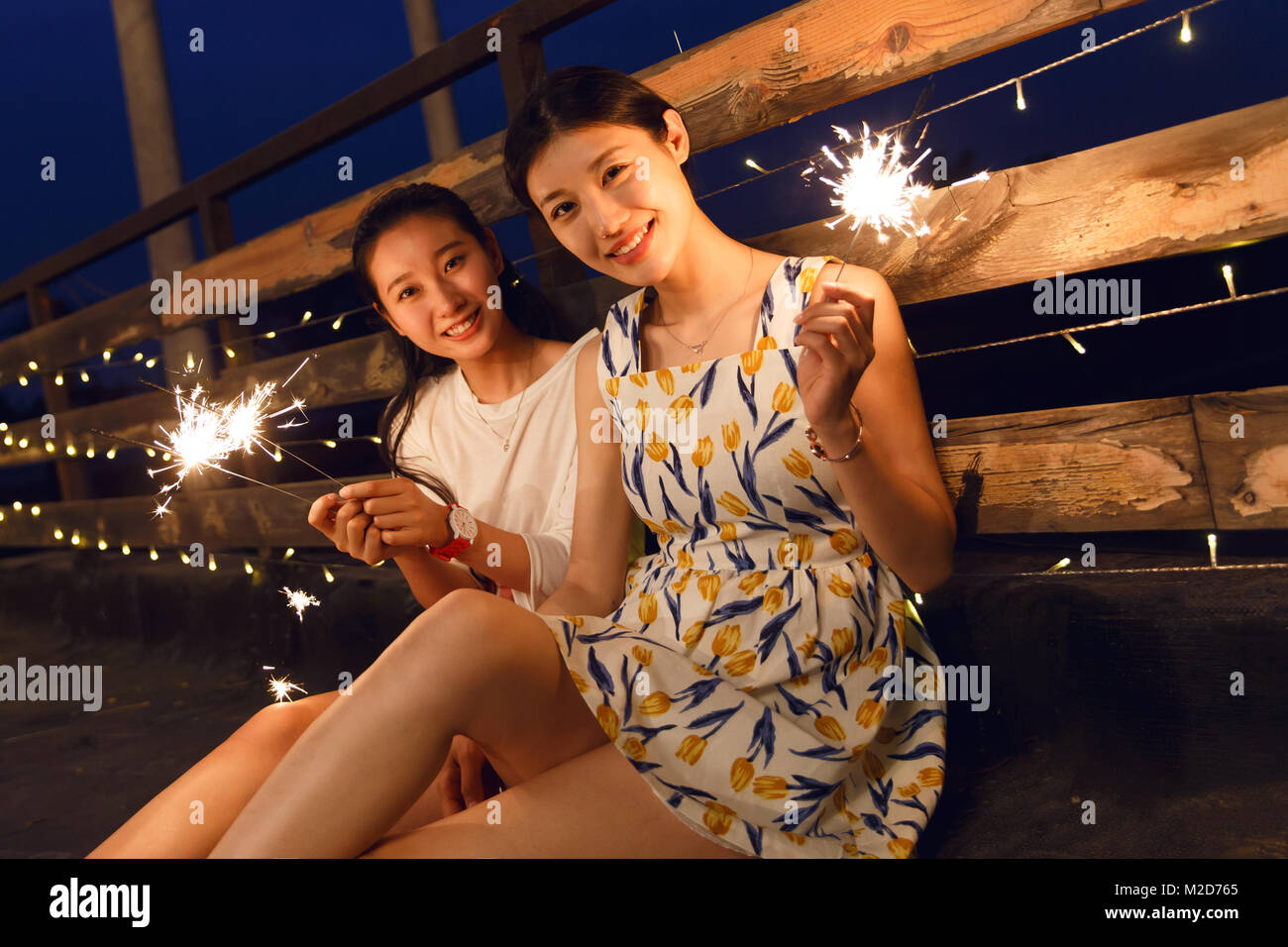 Two young women set off fireworks Stock Photo - Alamy
