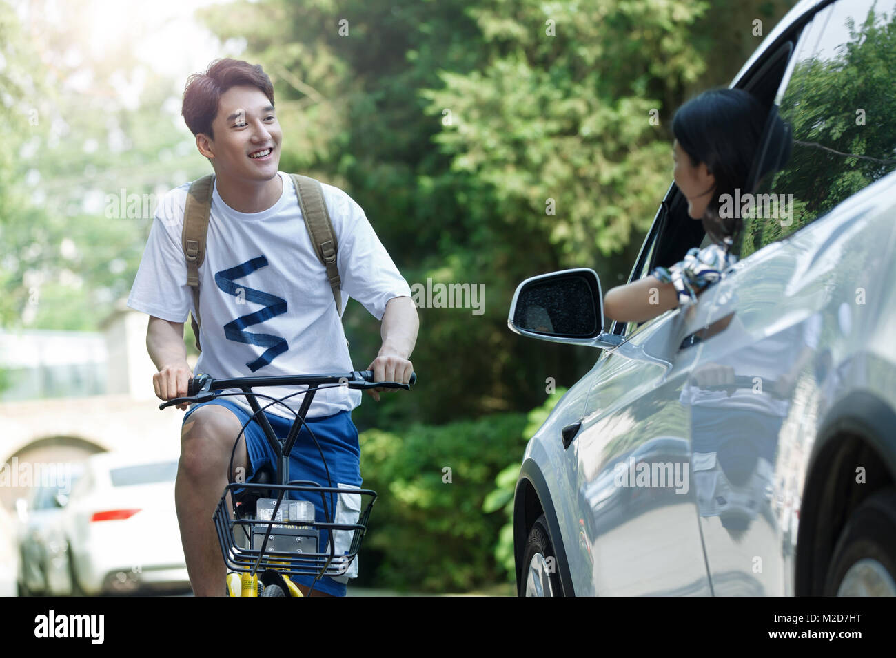 Young men ride bicycles Stock Photo - Alamy